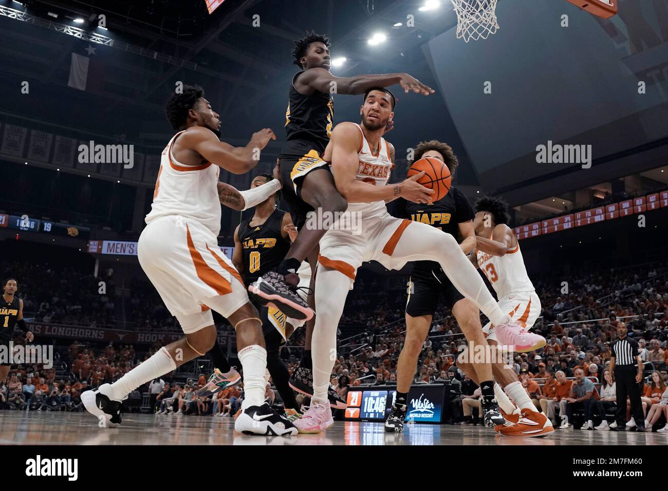 Texas forward Timmy Allen, right, grabs a rebound under Arkansas-Pine ...