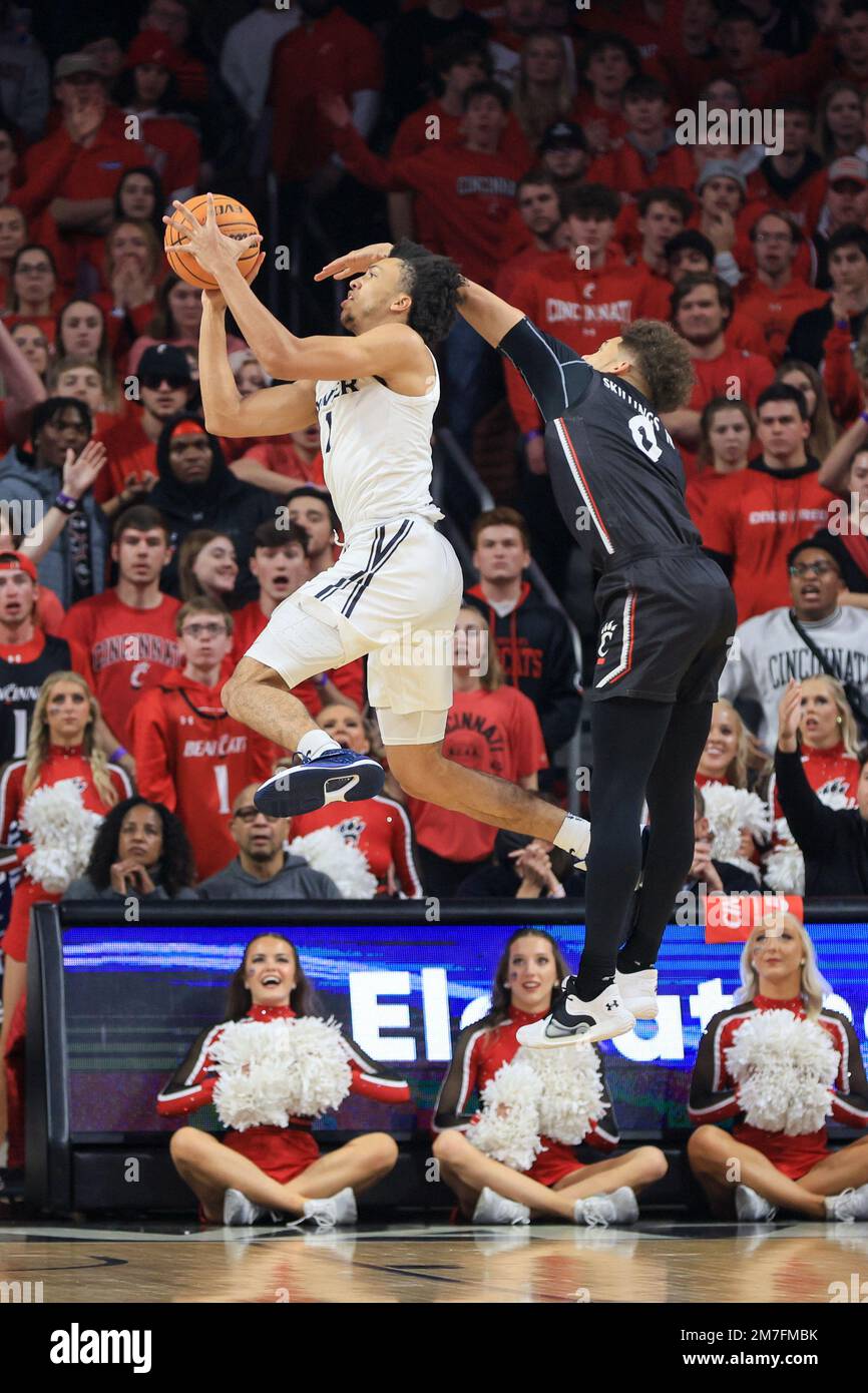 Xavier's guard Desmond Claude, left, is fouled by Cincinnati's guard ...