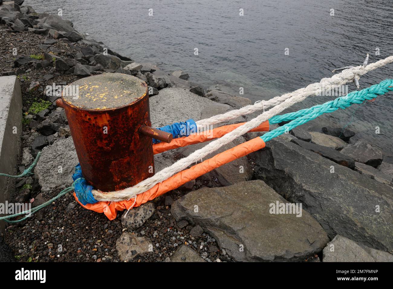 Bollard for mooring ships with ropes in Reine harbor in Norway Stock ...