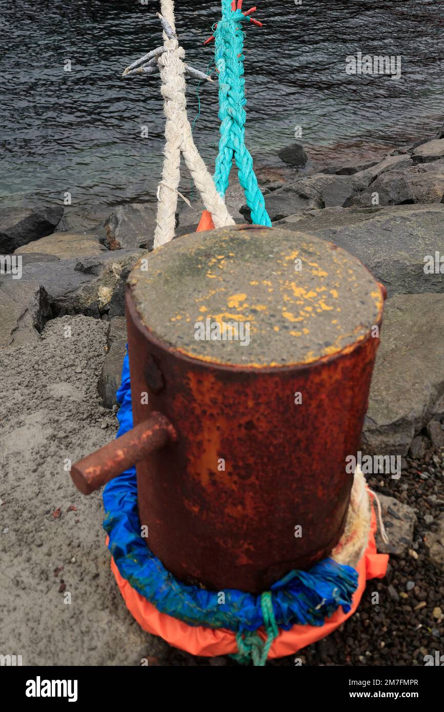 Bollard for mooring ships with ropes in Reine harbor in Norway Stock ...