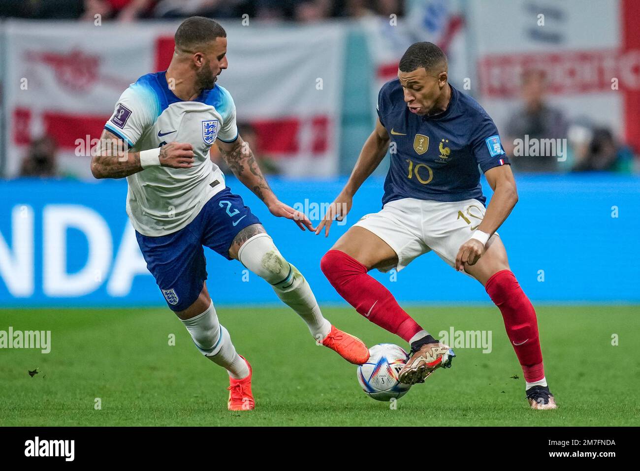 England's Kyle Walker, left, duels for the balls with France's Kylian ...