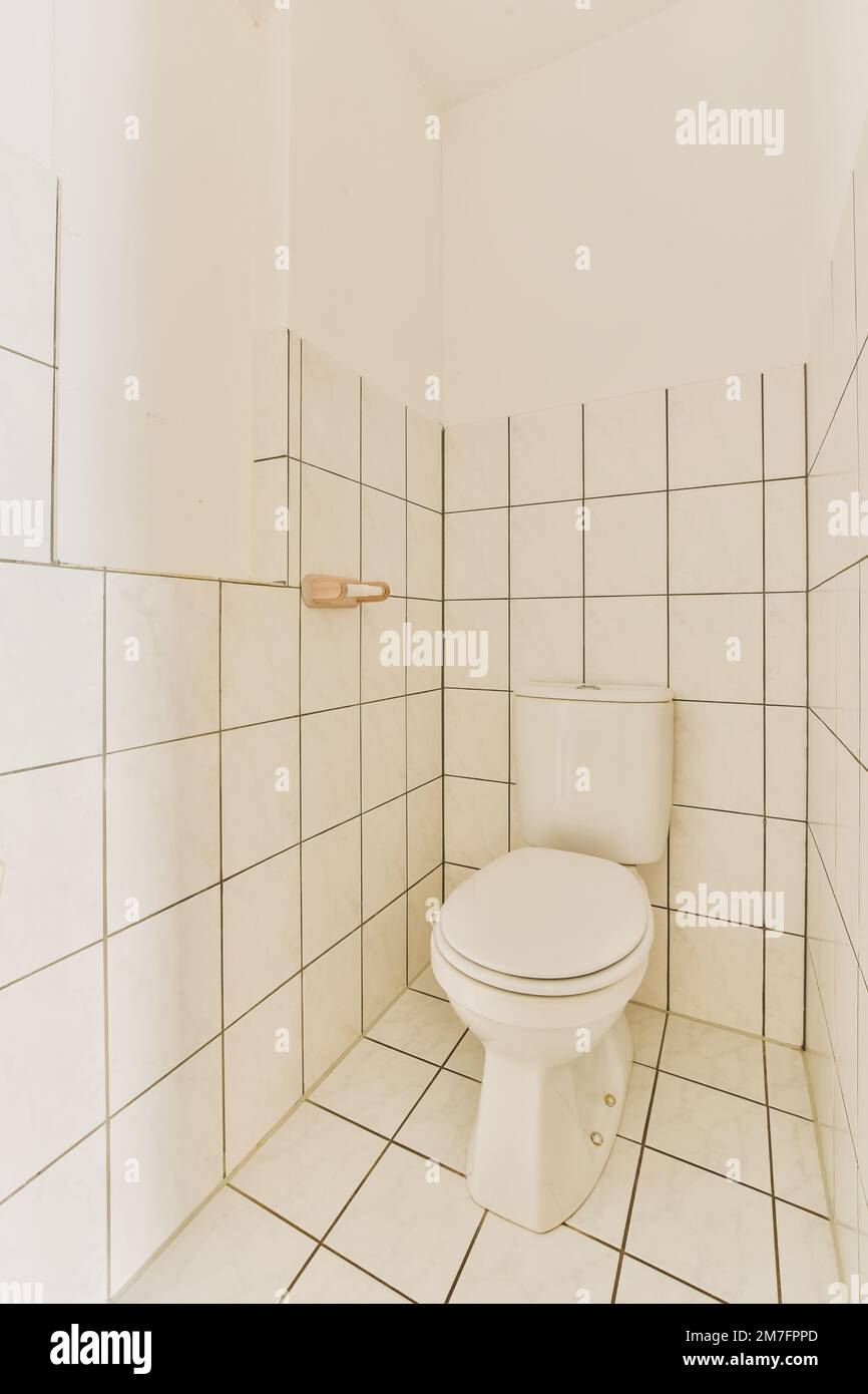 a bathroom with white tiles and black lines on the walls, along with a ...