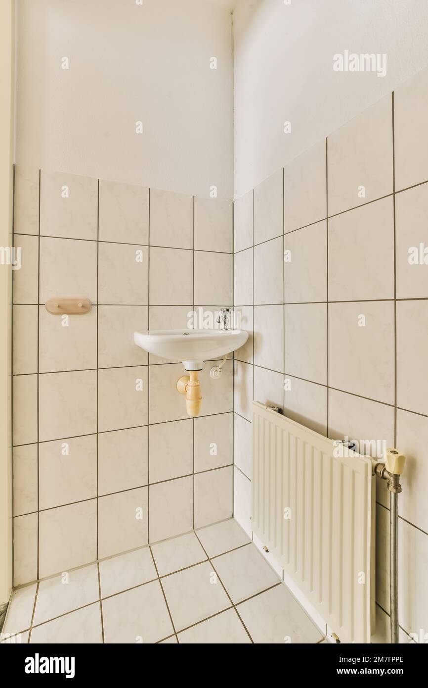 a bathroom with white tiles and black lines on the walls, along with a ...