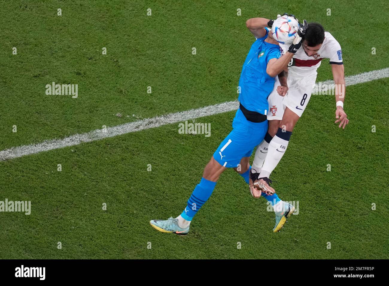 Morocco's goalkeeper Yassine Bounou, saves the ball next to Portugal's ...