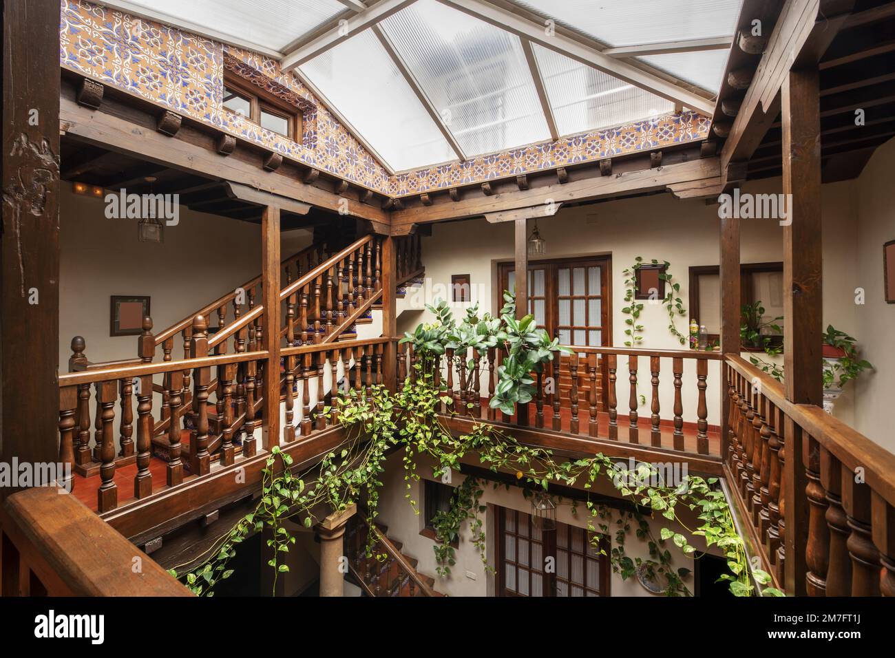 Atrium of an old house with wooden railings on the stairs and on the ...