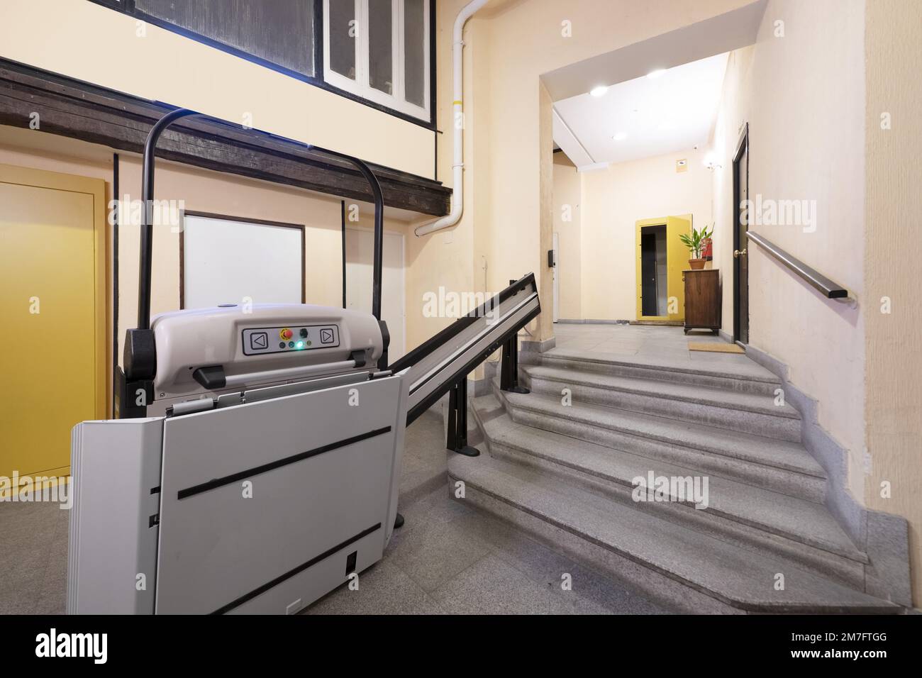 Entrance of an old house with a gray granite staircase and a ramp for ...