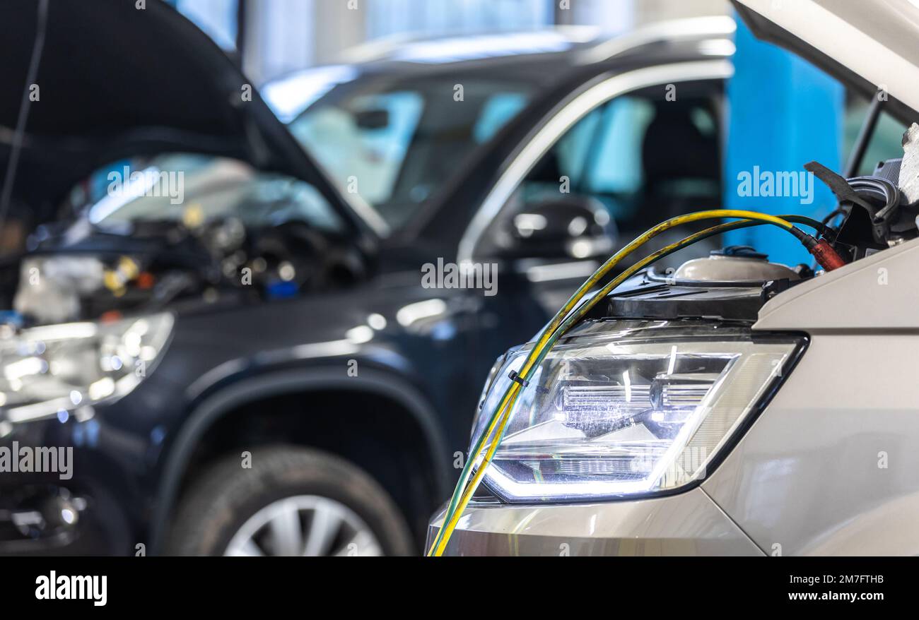Car service center concept, vehicle raised on lift at maintenance ...