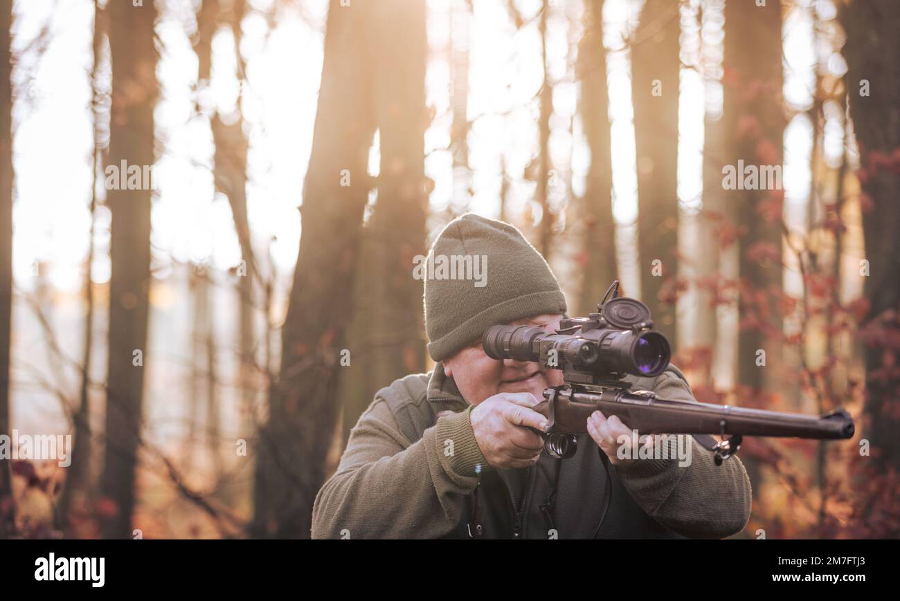 Autumn hunting season, hunter with rifle looking out for some wild ...