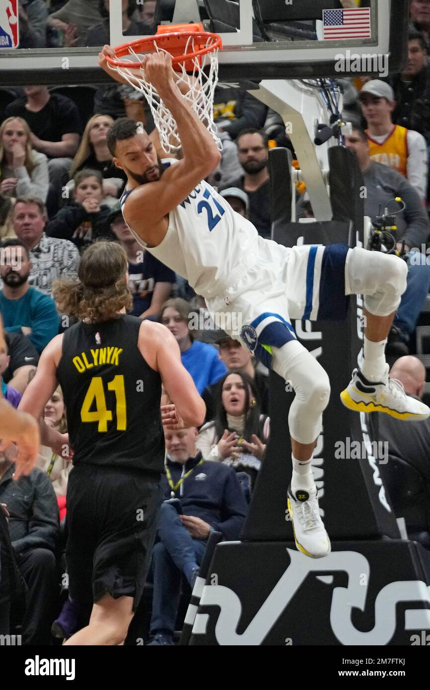 Minnesota Timberwolves center Rudy Gobert hangs from the rim after dunking against the Utah Jazz ...