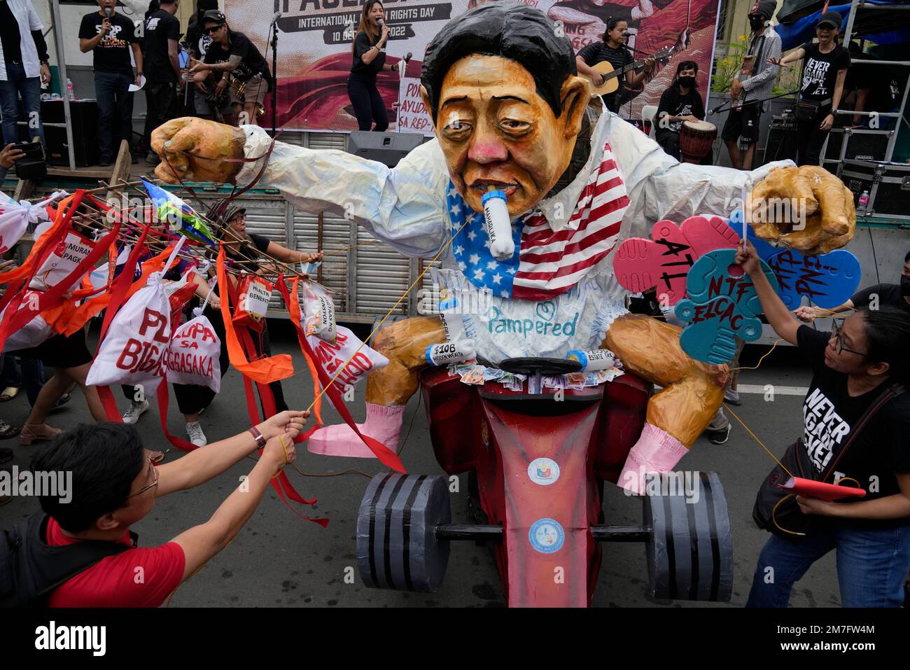 Protesters pull an effigy of Philippine President Ferdinand Marcos Jr ...