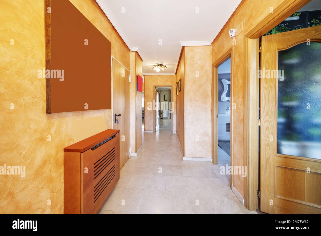 Entrance hall of a single-family house with pine wood doors to access ...