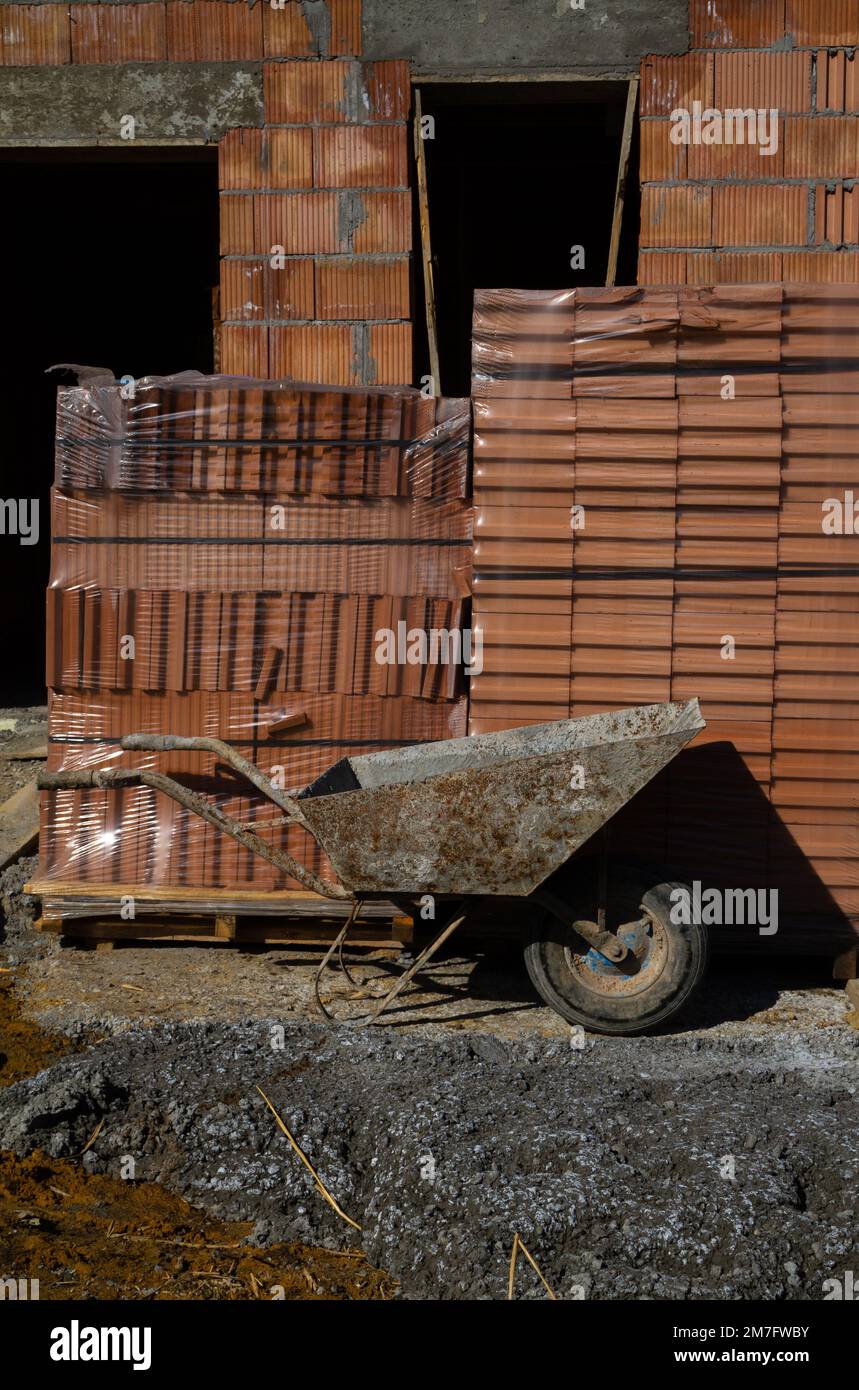 Wheelbarrow at the construction site of a new house building ...