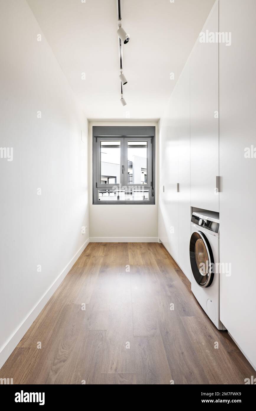 Ironing and washing room in an empty room with a wall covered with ...