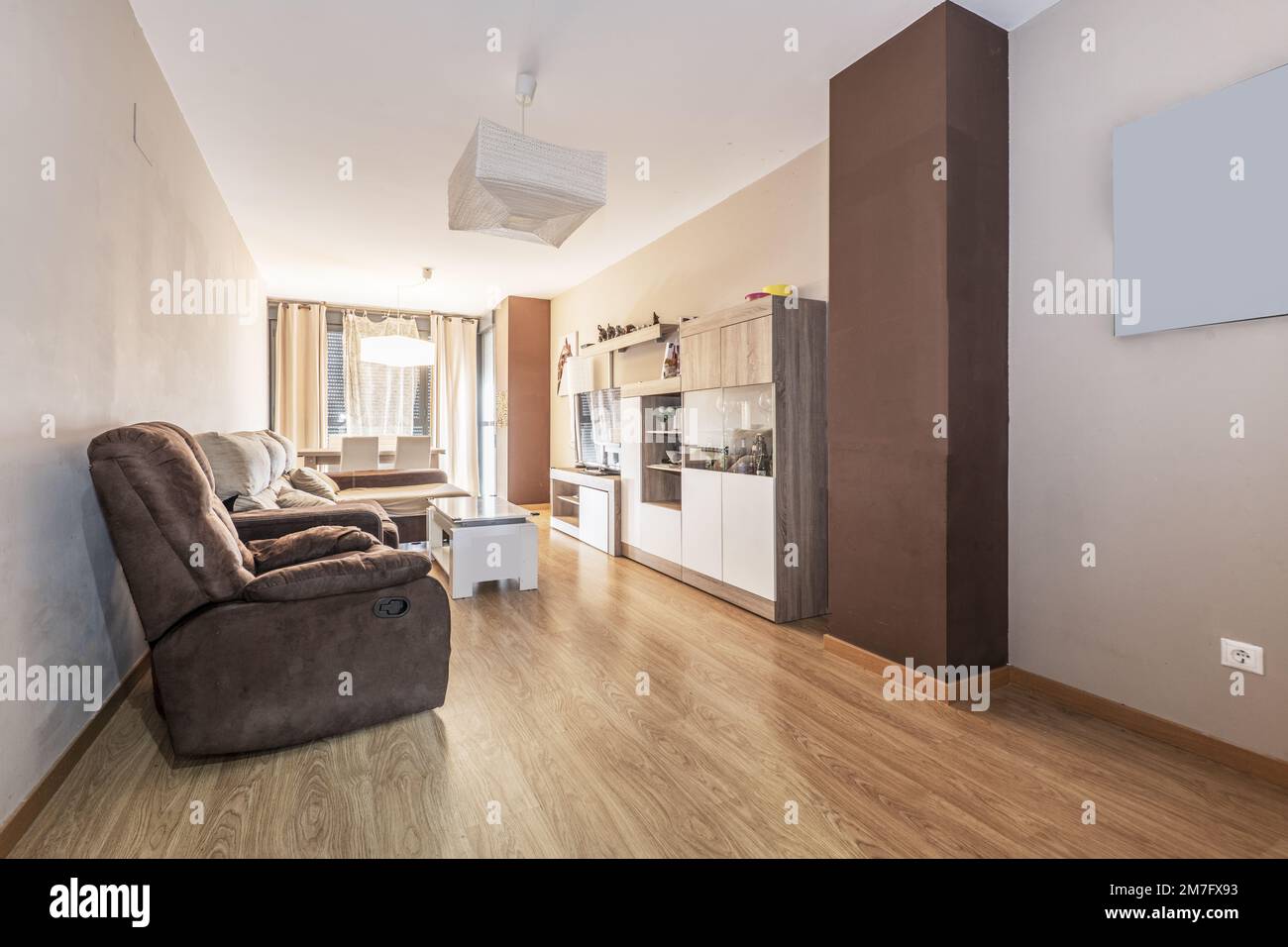 Living room with individual brown leather massage sofa, wooden flooring ...