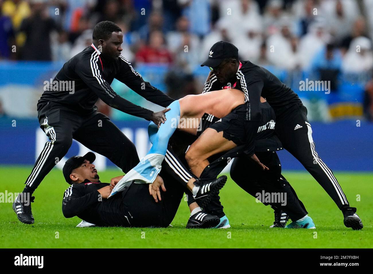 A man who invaded the field fights with security personnel during the ...