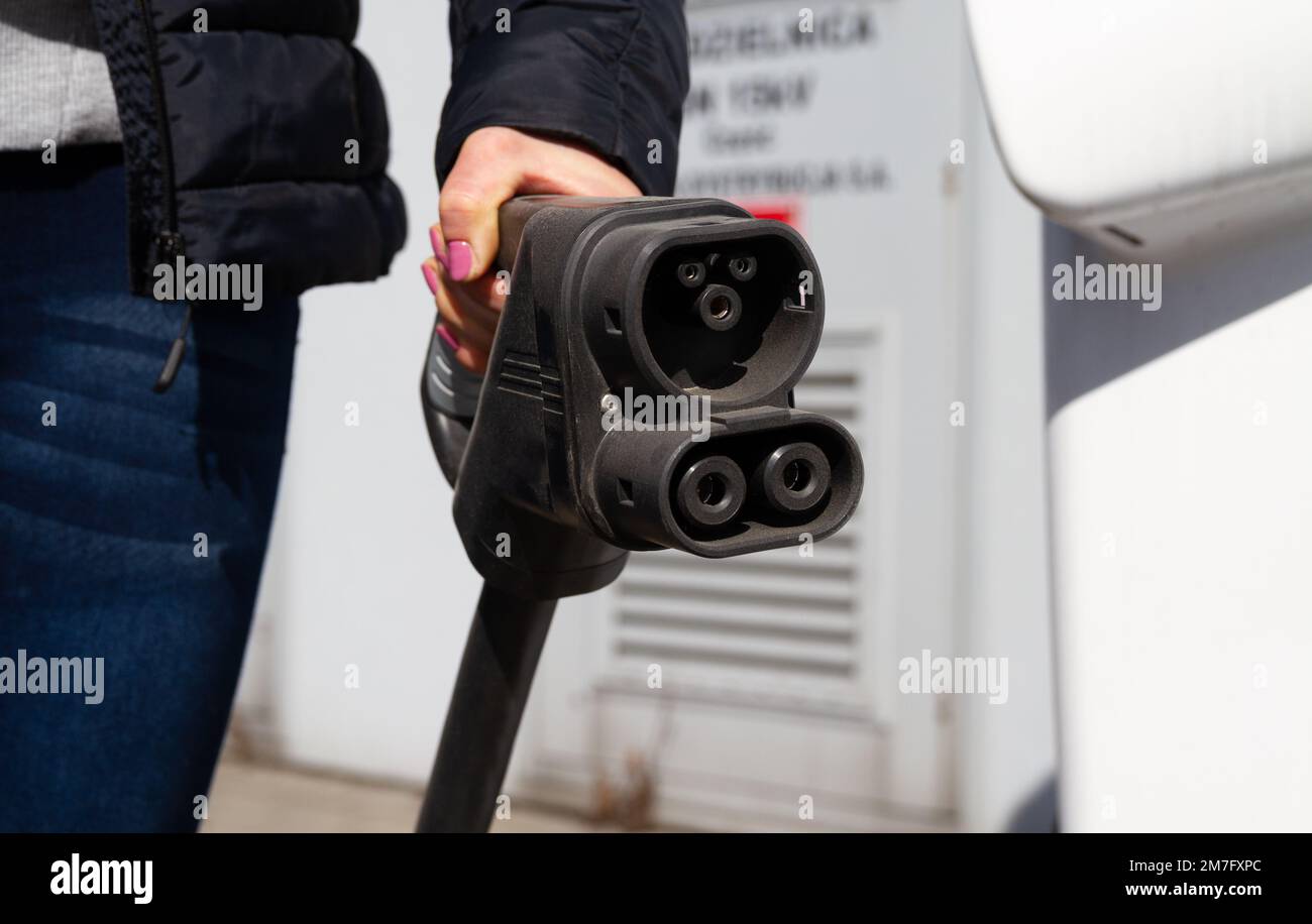 Female hand holding fast charging socket type 2. Combined Charging ... Female hand holding fast charging socket type 2. Combined Charging ...