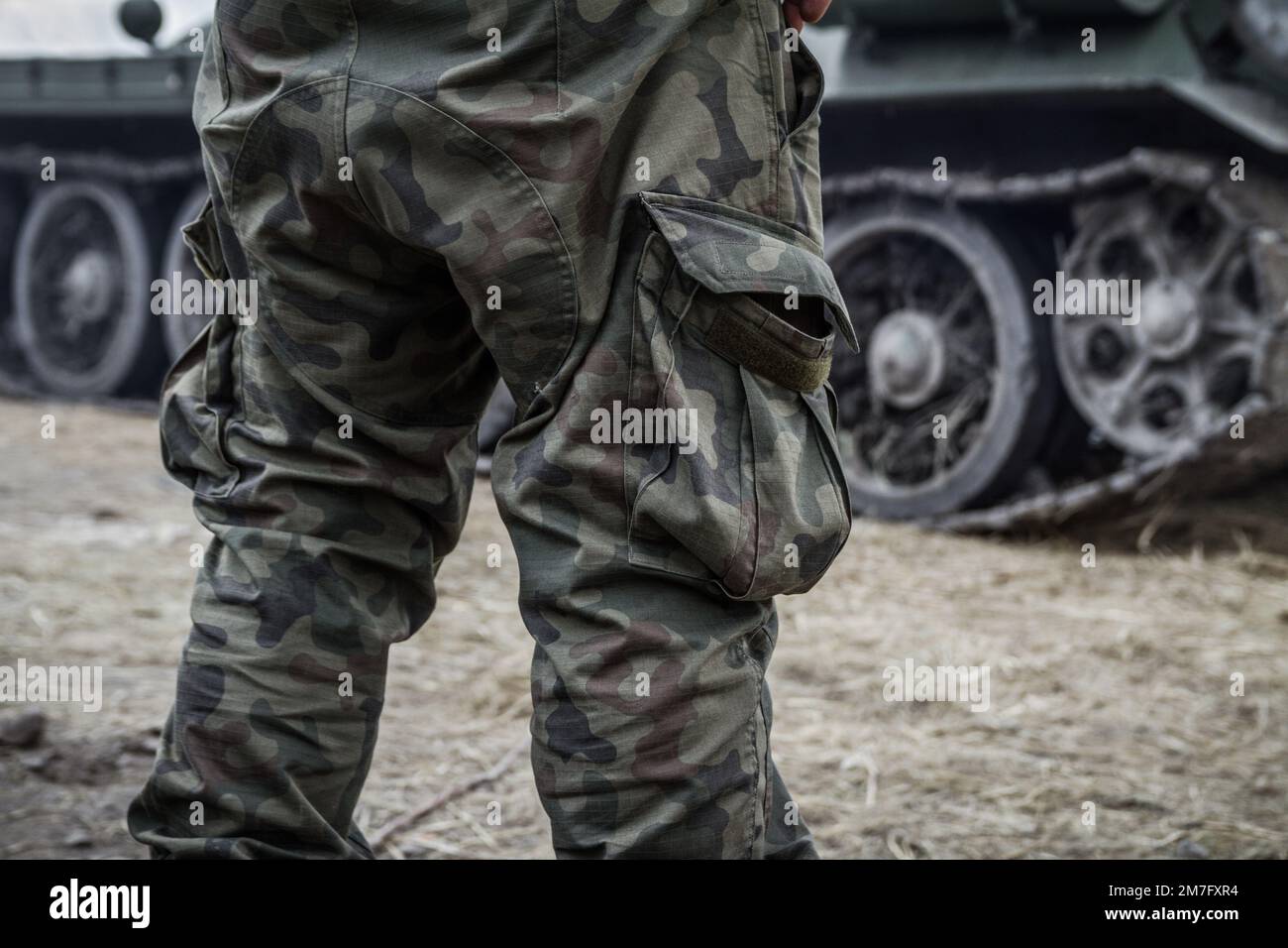 Soldier legs on a battlefield, wearing woodland camo military pants ...