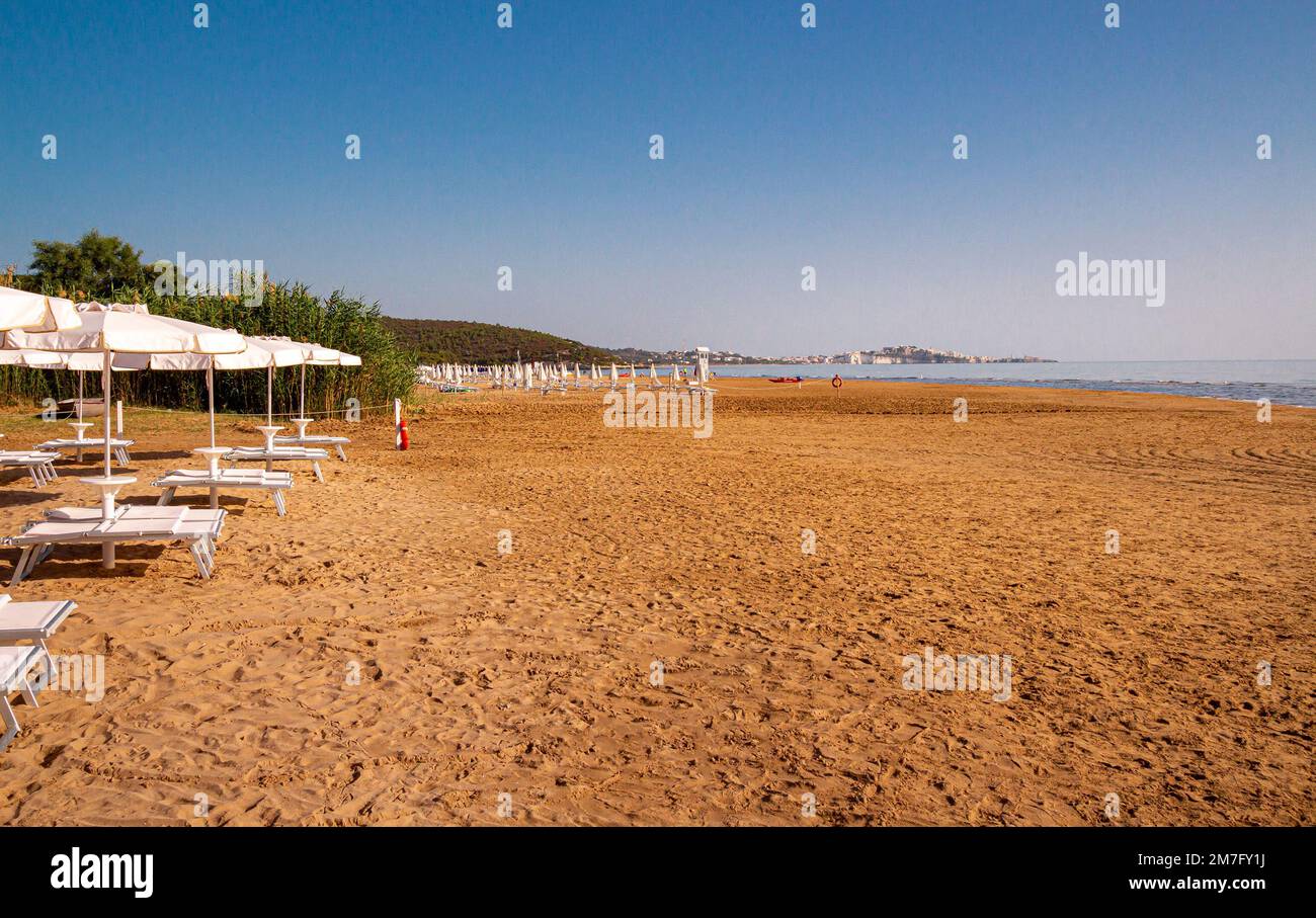 Spiaggia di Portonuovo beach, a sandy sunrise beach and in background ...