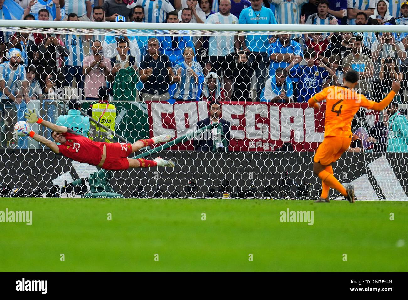 Argentina's goalkeeper Emiliano Martinez fails to save a kick of Virgil ...