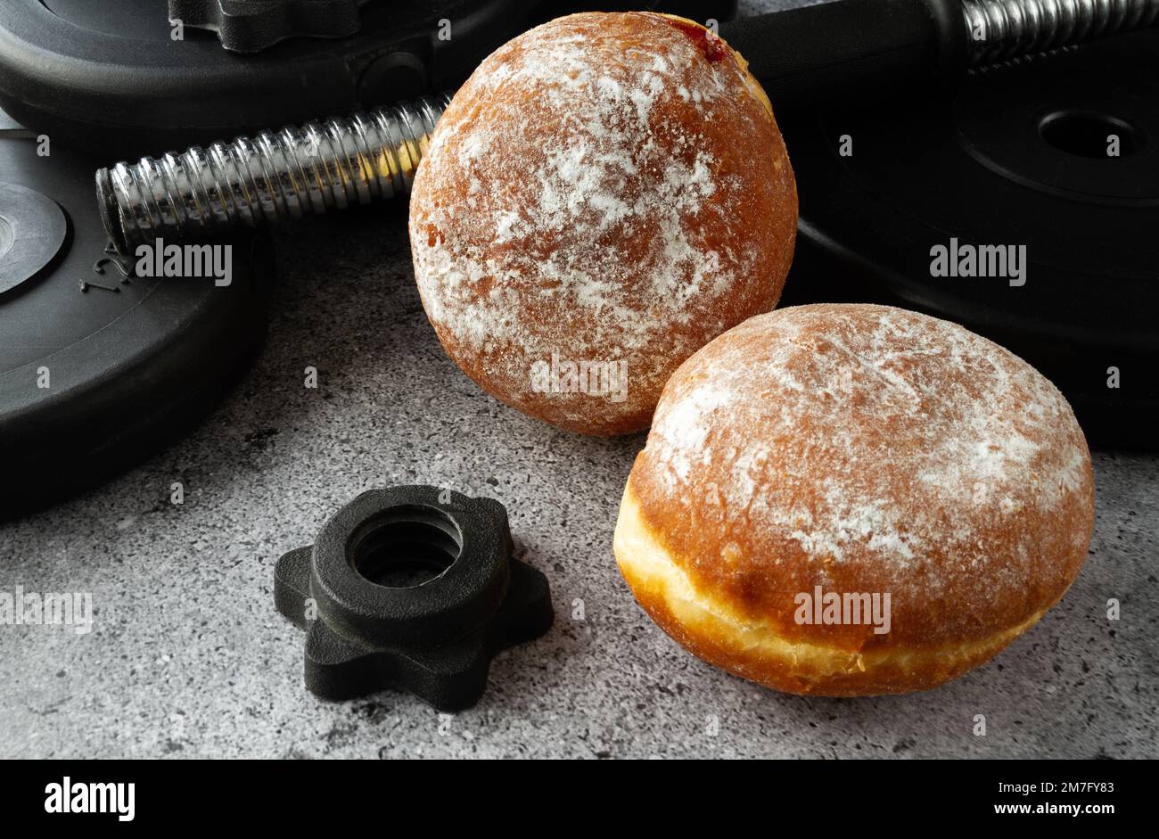 Dumbbells barbell weight plates and Polish pączki deep-fried doughnuts ...