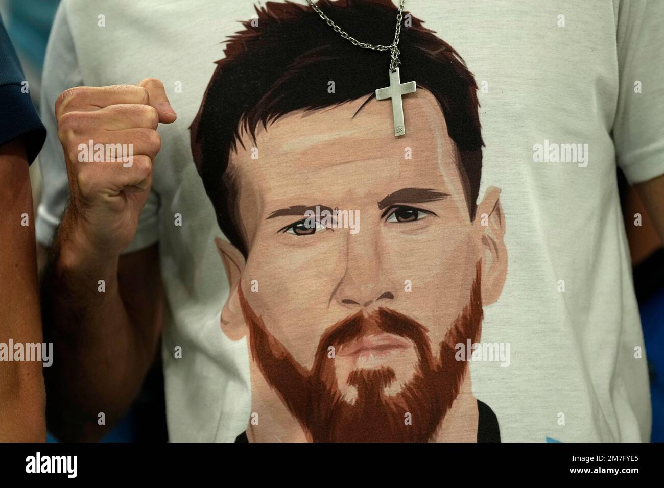 A fan wears a shirt with the face of Argentina's Lionel Messi during ...