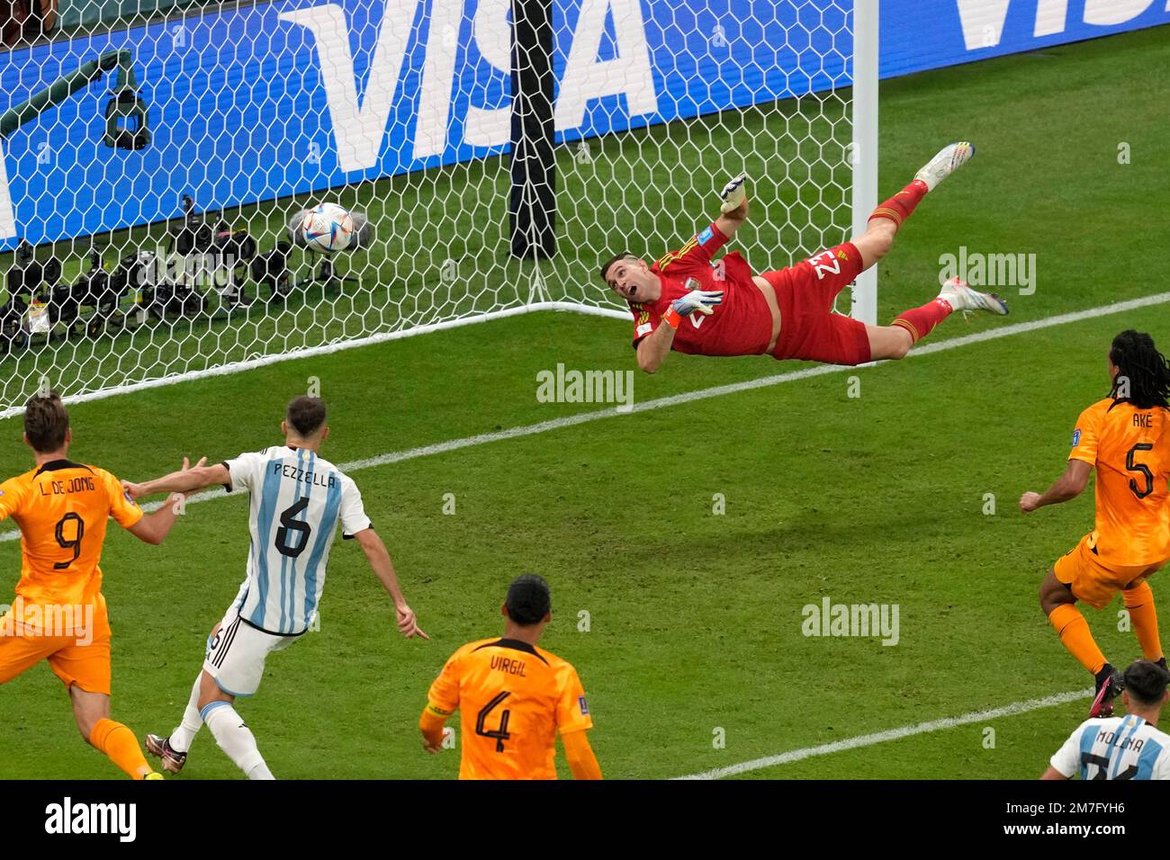 Argentina's goalkeeper Emiliano Martinez dives but fails to save the ...