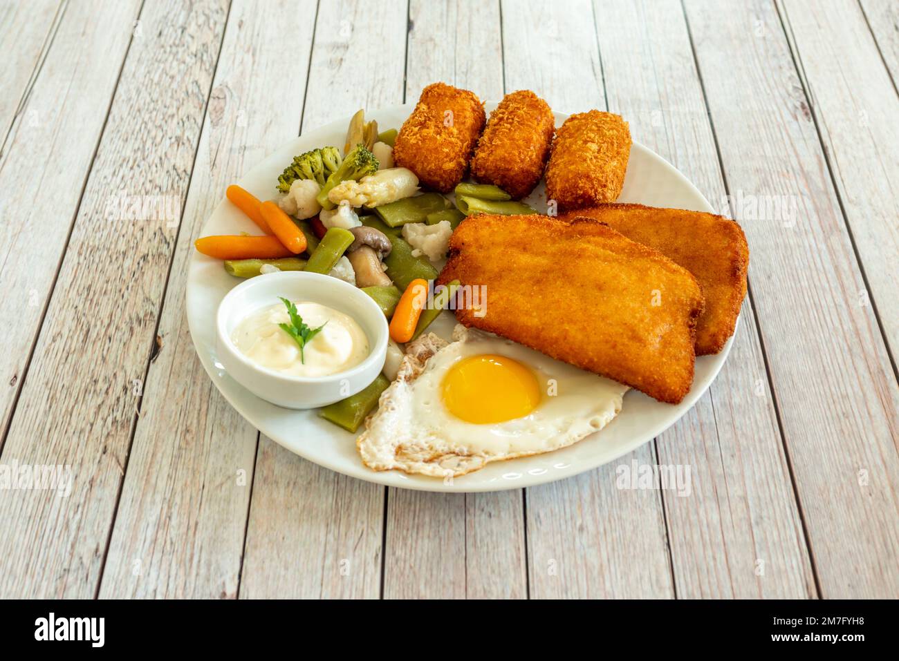 A delicious combination plate of blanched vegetables, croquettes ...