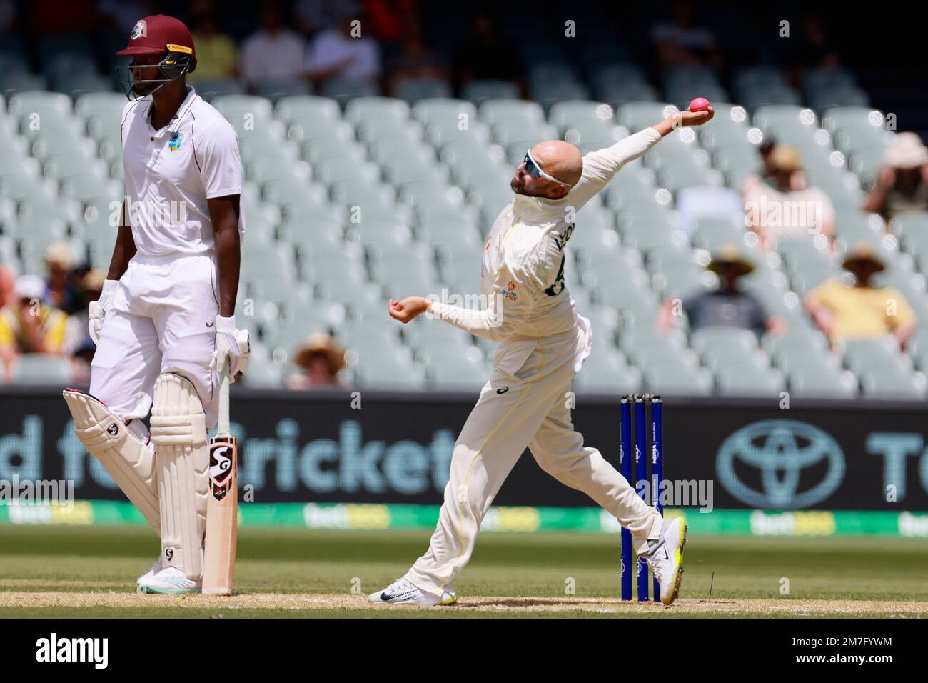 Australia's Nathan Lyon, right bowls as the West Indies' Anderson ...
