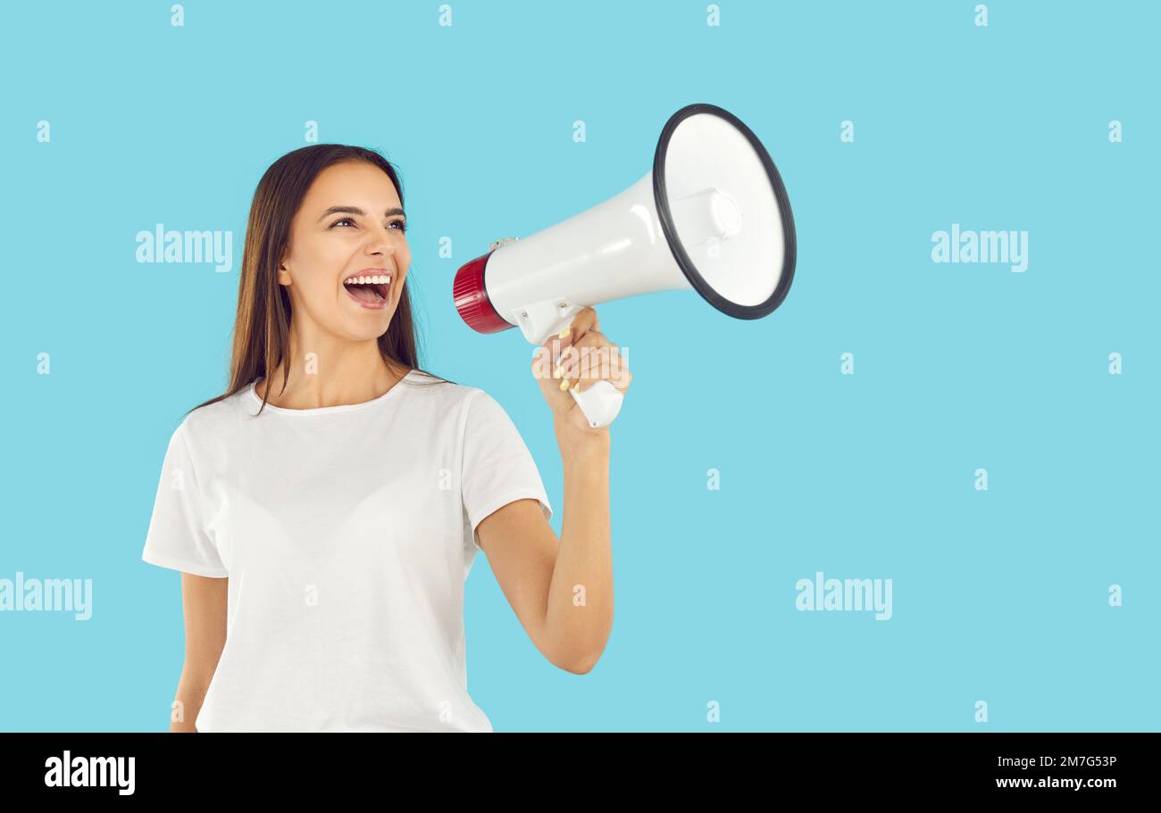 Smiling young woman shouting into megaphone making recommendation Stock ...
