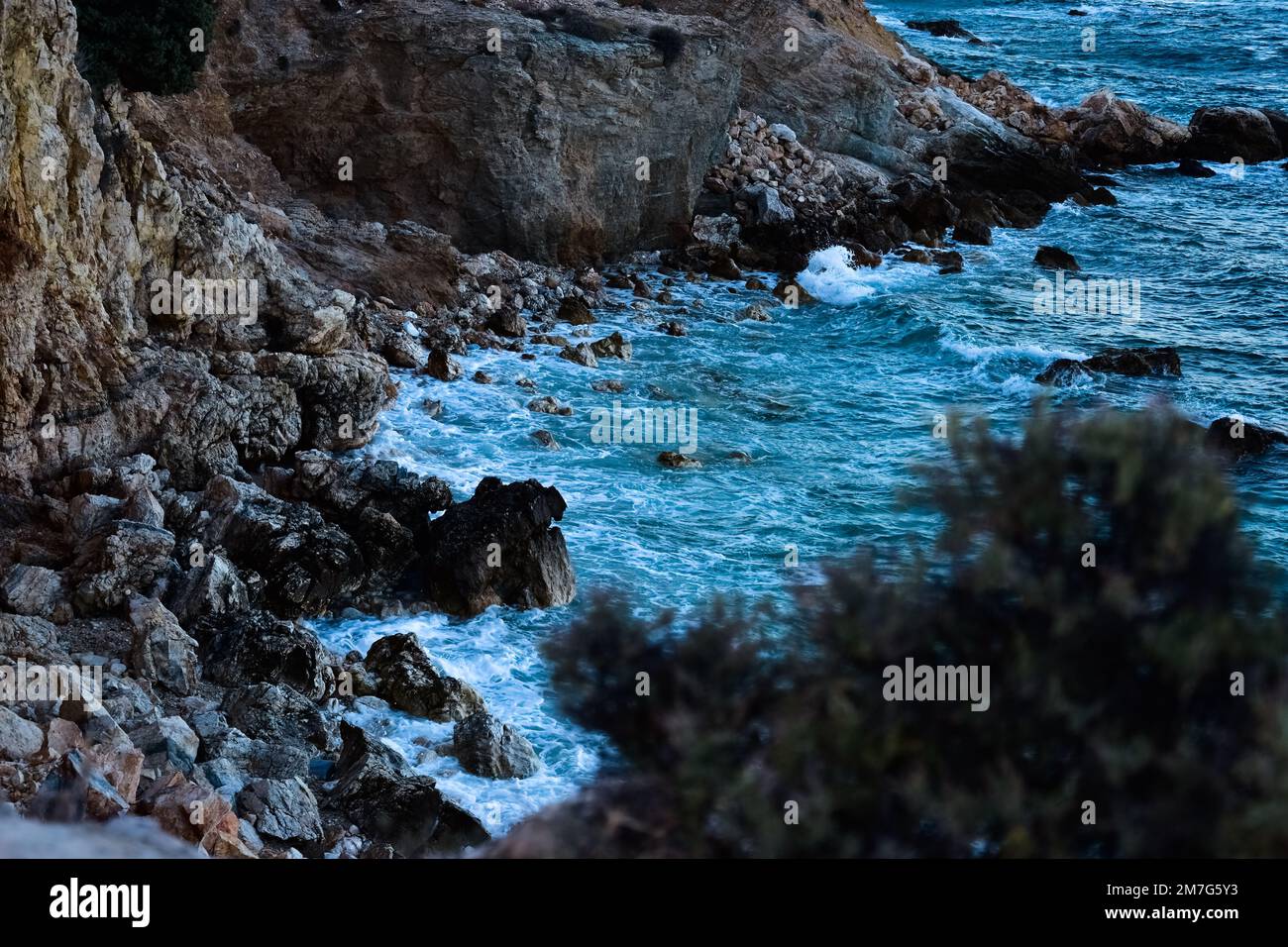 A beautiful shot of foamy sea waves covering a rocky coastline Stock ...