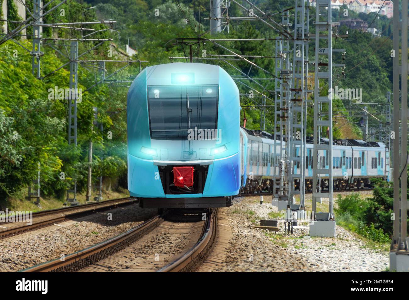 Suburban electric train of blue color goes turn from a distance with ...