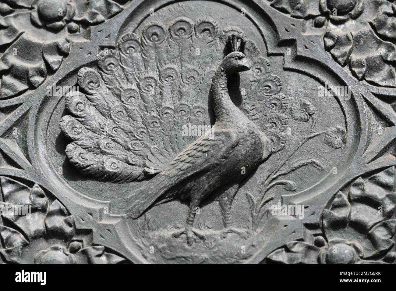 Cast iron relief of a peacock Stock Photo - Alamy