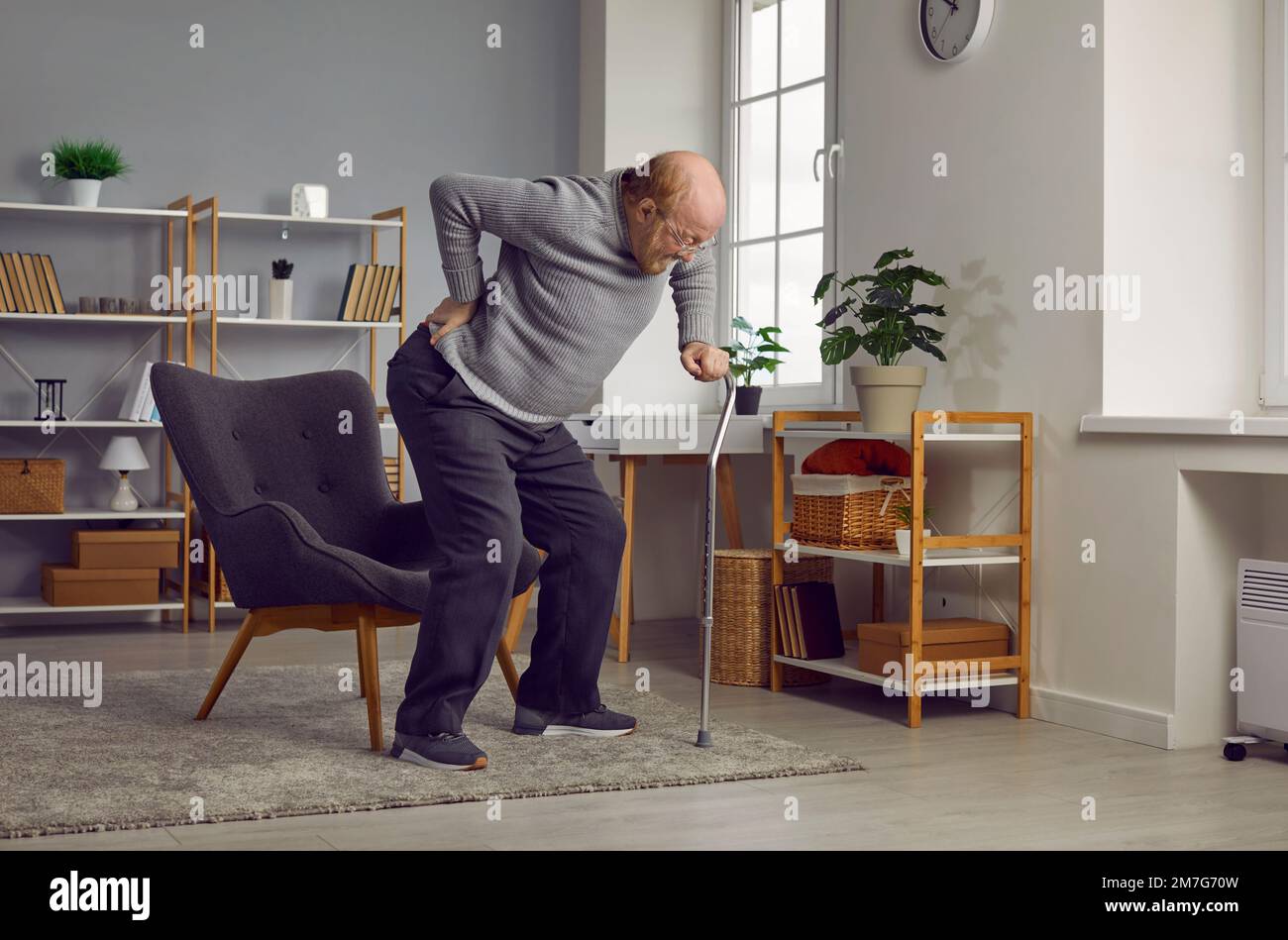 Upset senior man suffering from lower back pain Stock Photo - Alamy