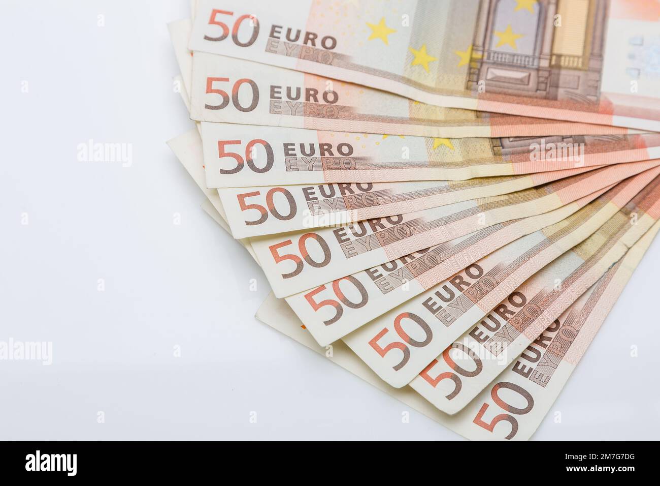 a bunch of 50 Euro bank notes on a white surface Stock Photo - Alamy