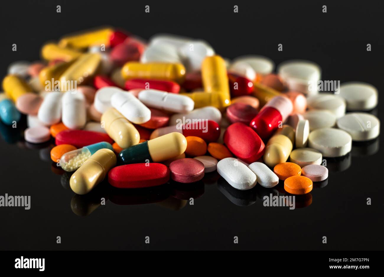 Pile of different medicaments pills, capsules, on black background with ...