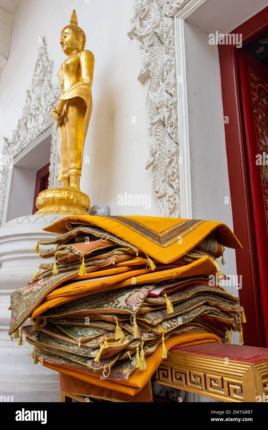 A pile of decorative carpets for Buddhist monks at the entrance to the ...