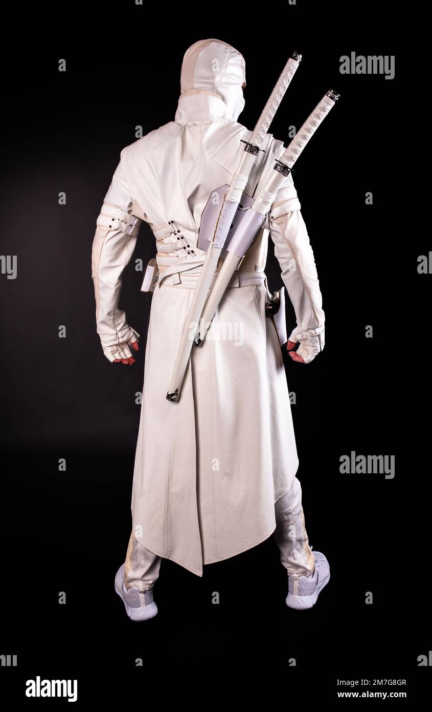 Standing man with his back in the form of a combat ninja posing with ...