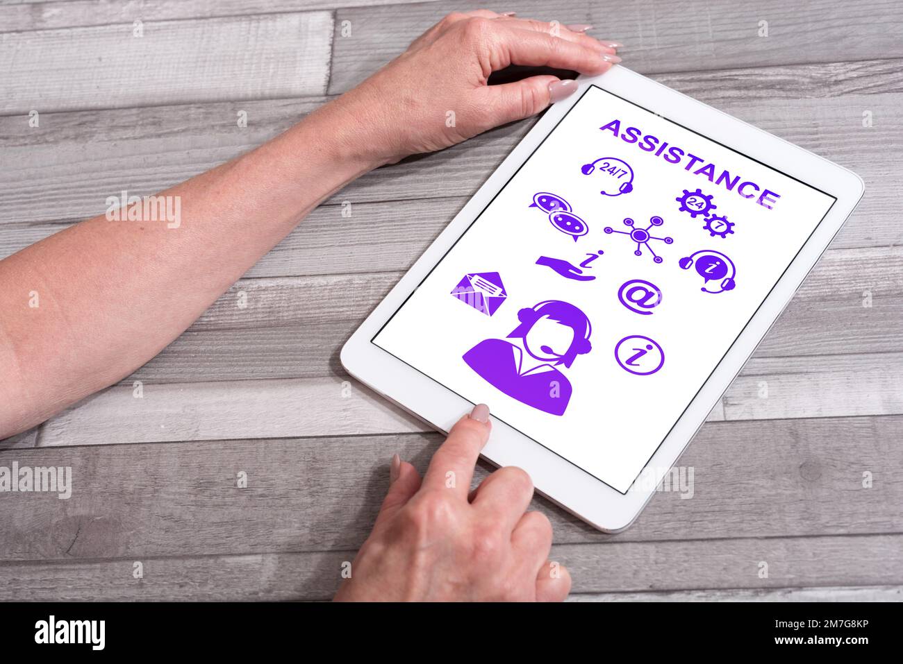 Assistance concept shown on a tablet used by a woman Stock Photo - Alamy