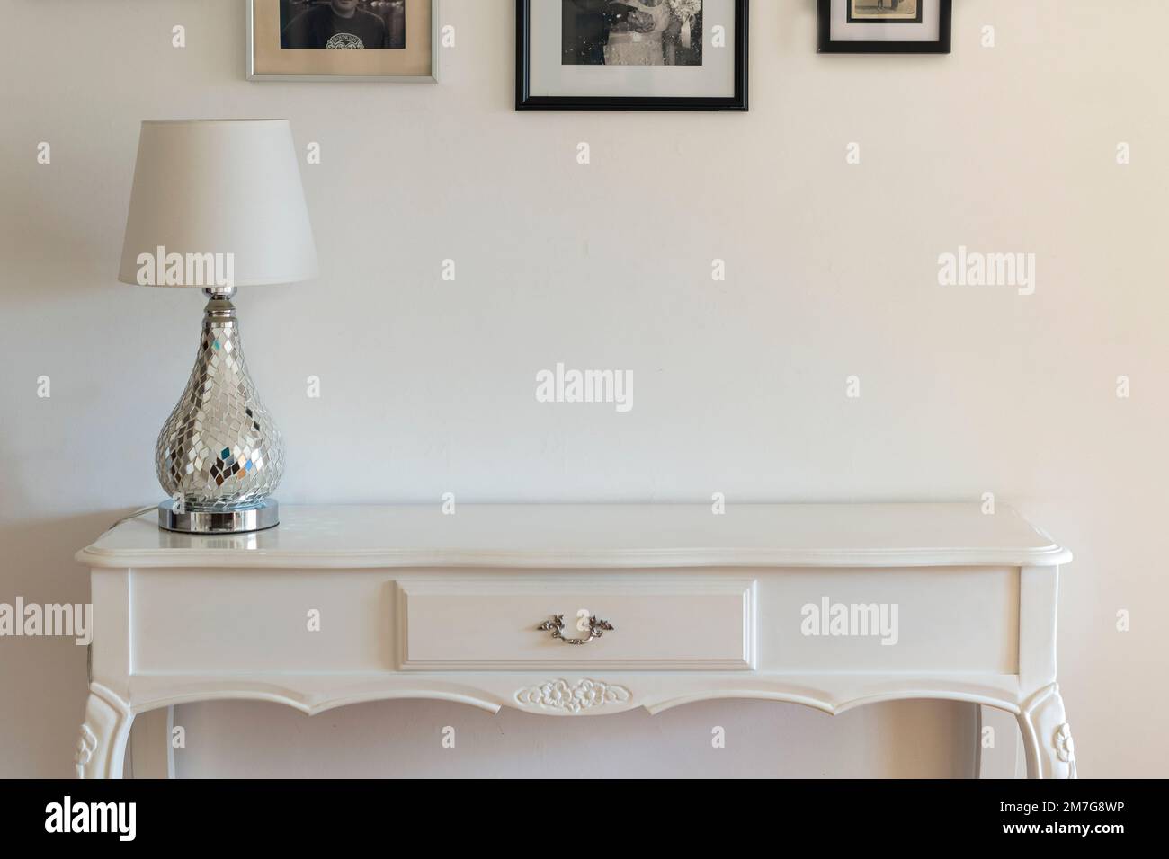 White classic console with a lamp on it Stock Photo - Alamy