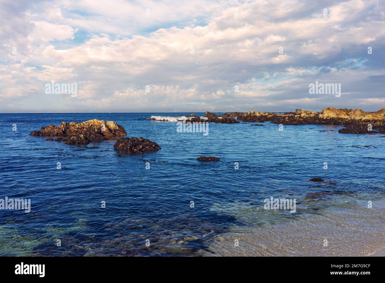 Ocean view of Monterey Bay with cloudy sky and rocky shore Stock Photo ...