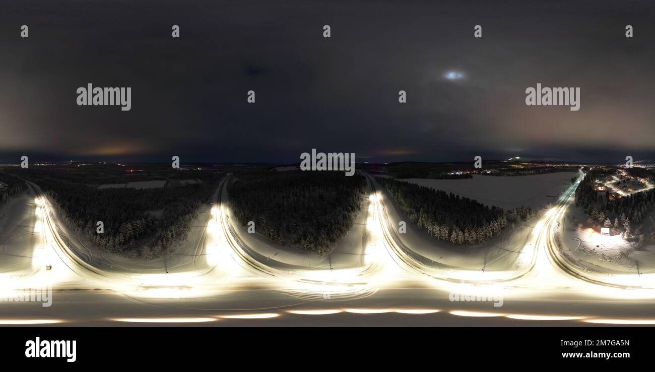 An aerial panoramic view of slightly illuminated empty suburban roads ...