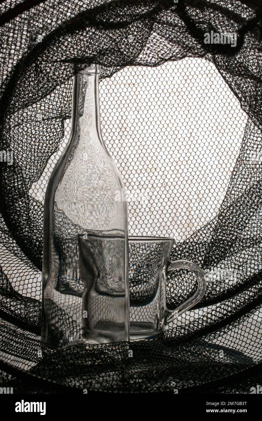 Still life with glass objects on a grid background Stock Photo - Alamy