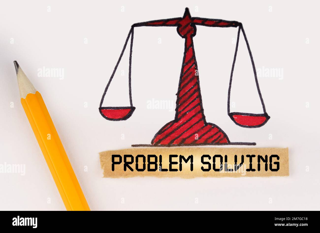 Legal concept. Next to the painted scales of justice lies a pencil and ...