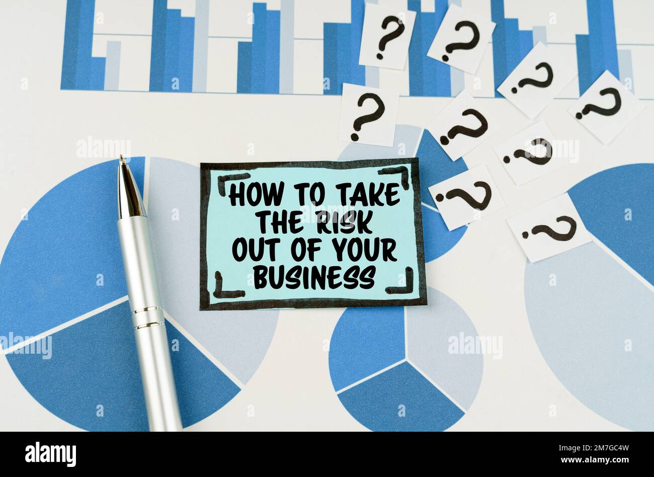 business question concept. On the blue diagrams lies a pen, questions ...