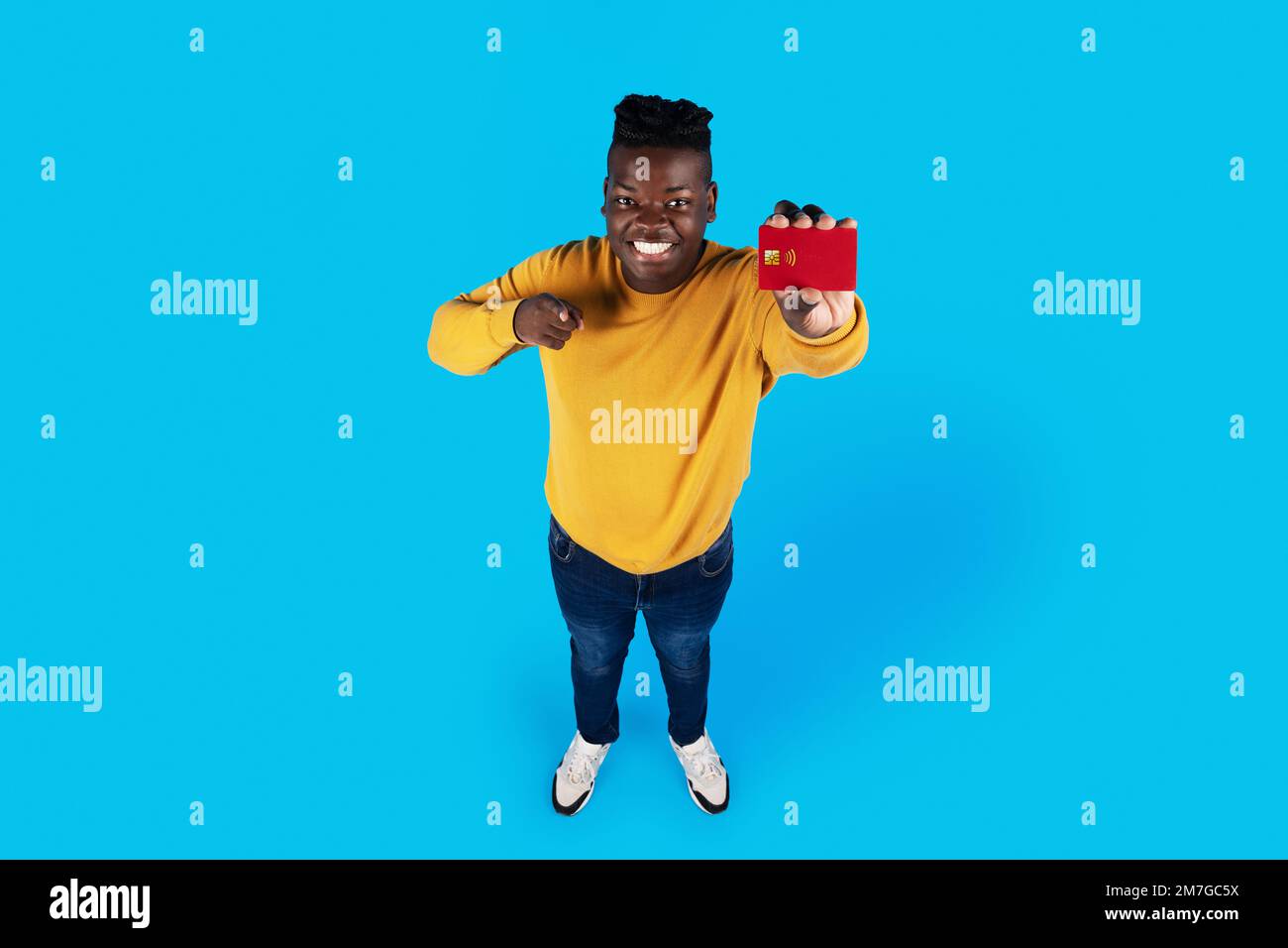 Cheerful Black Guy Holding Credit Card In Hand And Pointing At Camera ...