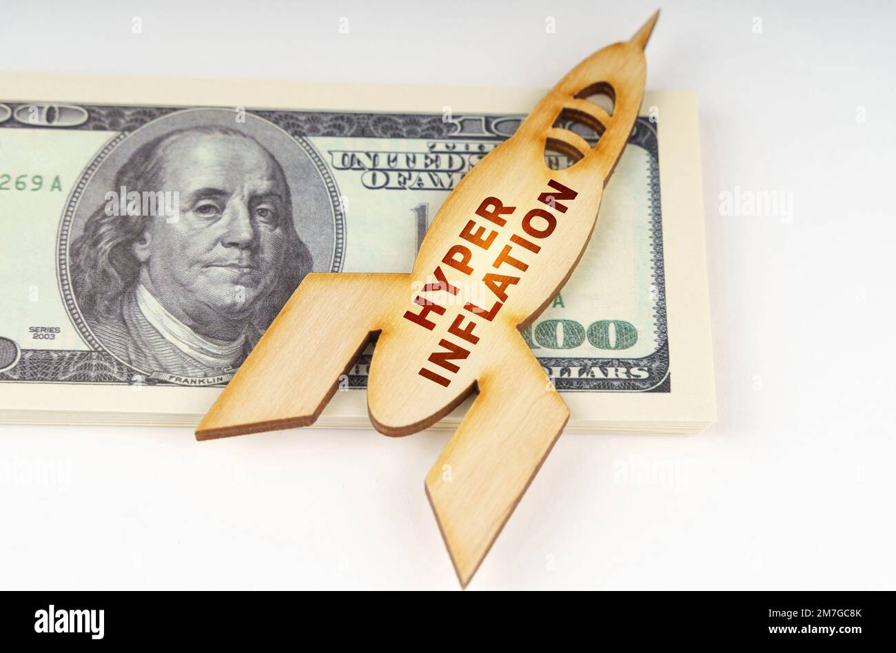 Business concept. On the dollars lies a wooden model of a rocket with ...