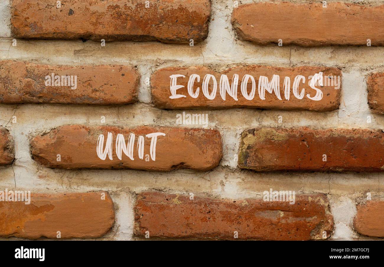 Unit economics symbol. Concept words Unit economics on brown brick wall ...