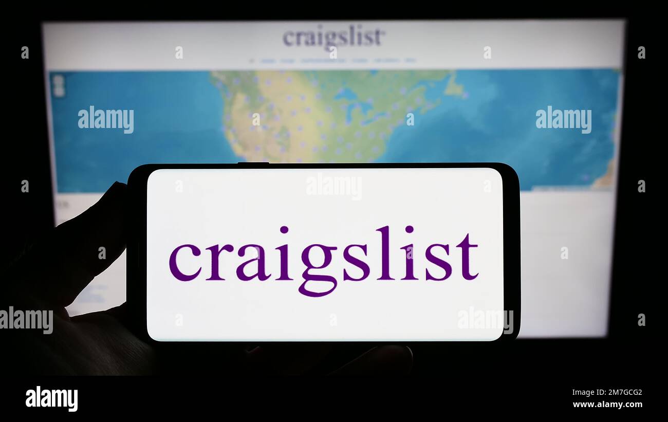 Person holding smartphone with logo of classified advertisements ...