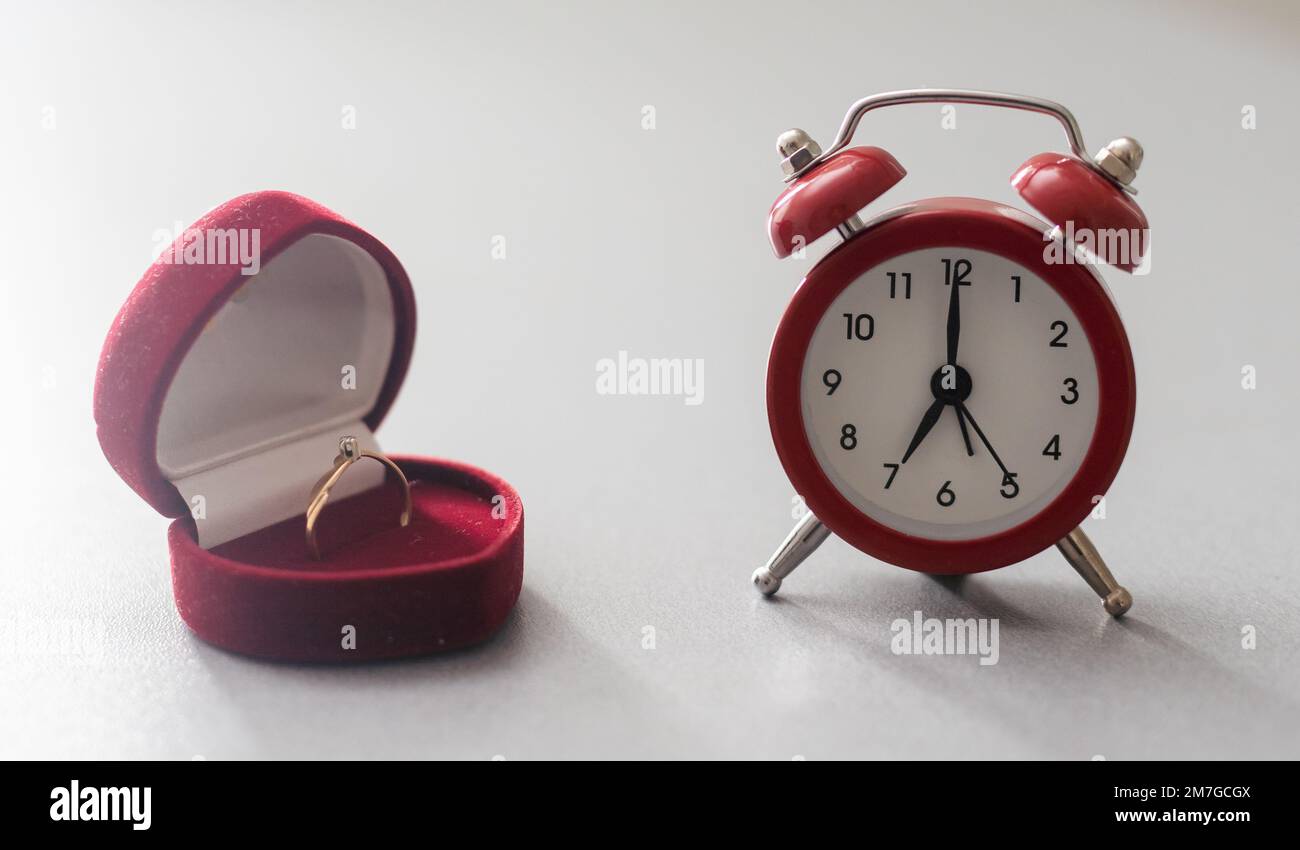 Wedding ring, alarm clock Tell time in life Stock Photo - Alamy