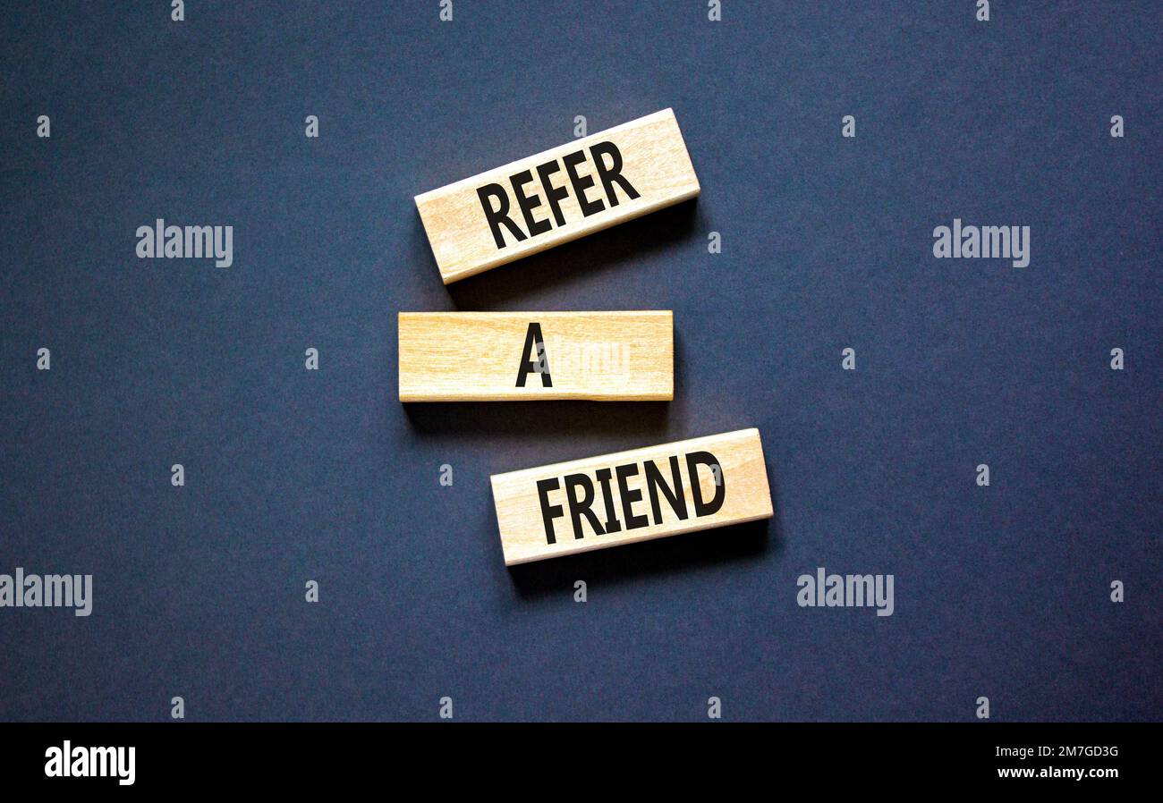 Refer a friend symbol. Concept words Refer a friend on wooden blocks on ...